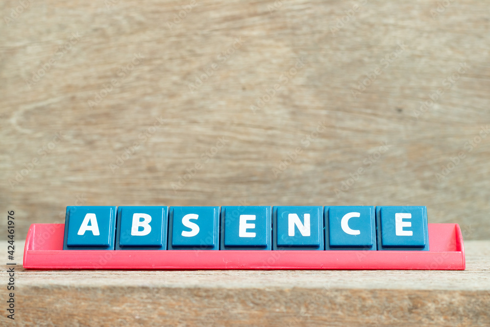 Tile alphabet letter with word absence in red color rack on wood ...
