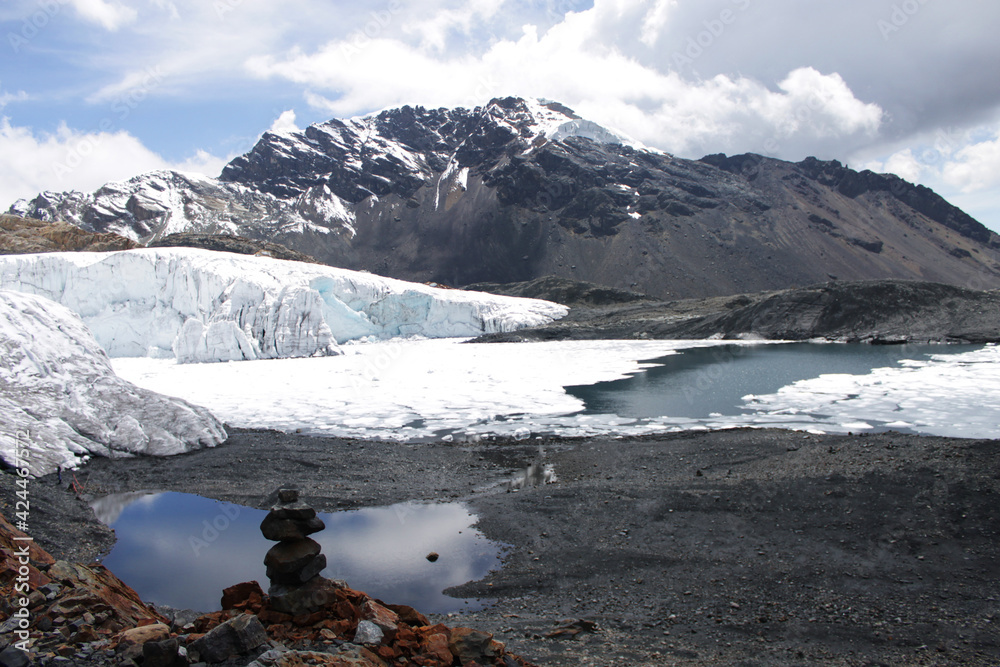 Glacier in huaraz peru south america, with a cold mountain lake and a ...