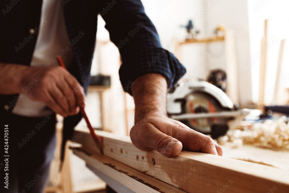 Carpenter makes pencil marks on a wood plank Stock Photo | Adobe Stock