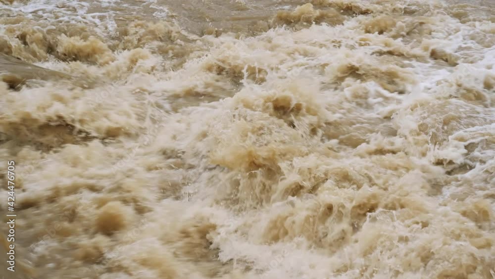 Flooding river, foamy stream of dirty water. Rivers flood. Crowded ...
