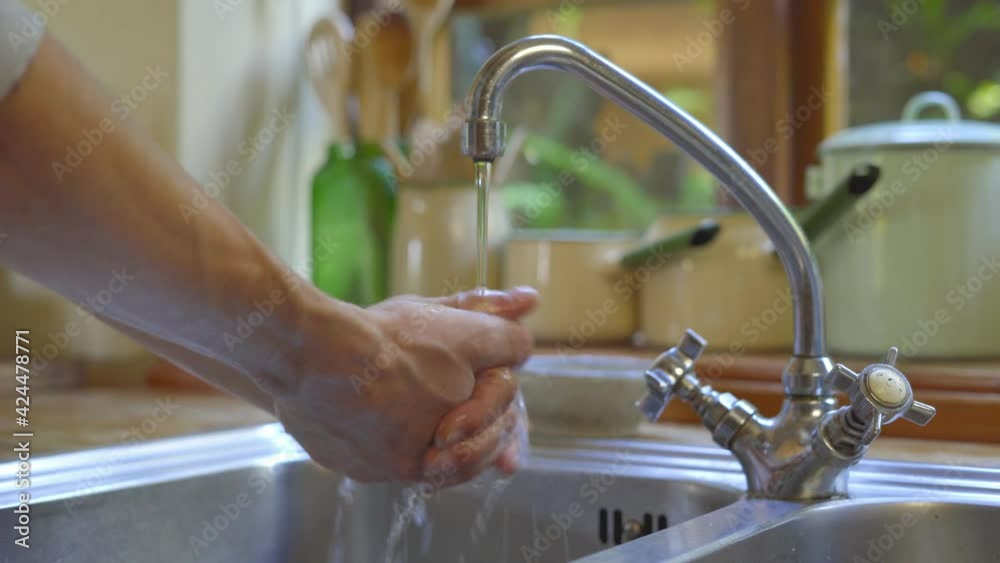 Side angle close up shot of a Caucasian person washing, lathering and ...