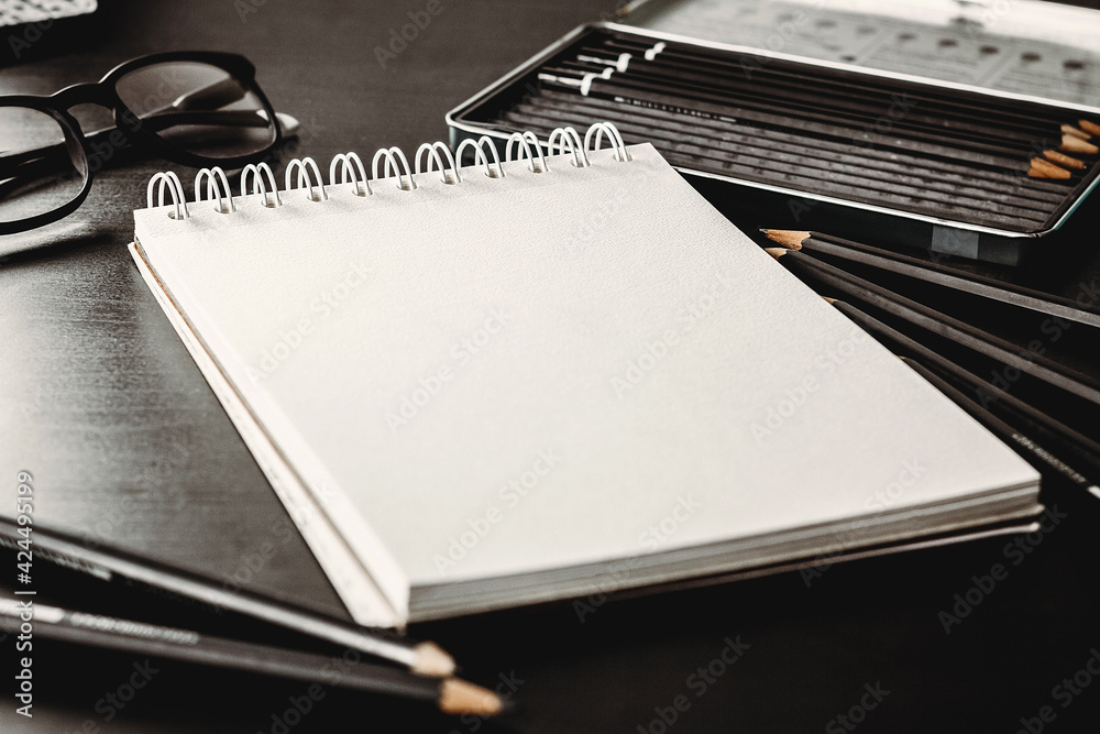 Blank notepad with white sheets on a dark table background. Writing ...