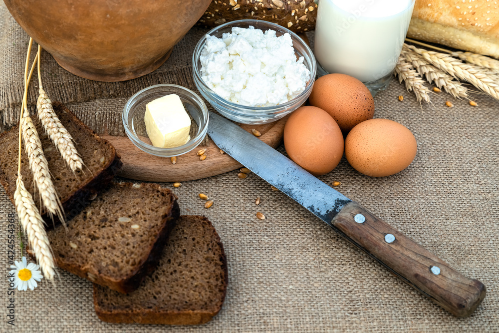 Organic food - milk, bread, eggs, cheese, butter, knife, lying on the ...
