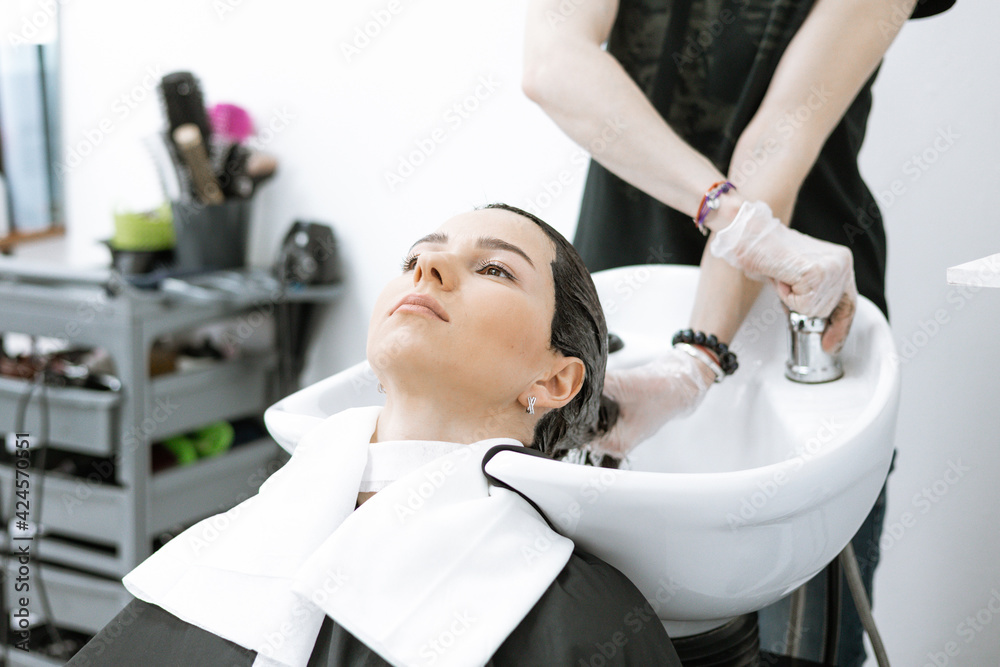 washing off hair care products in the beauty salon, washing hair in the ...