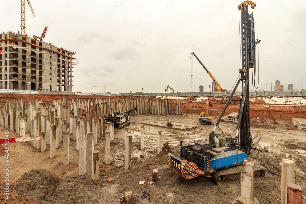 Pile driving in foundation pit for construction of apartment building ...