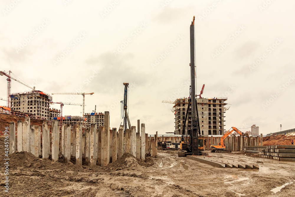 Pile driving in foundation pit for construction of apartment building ...