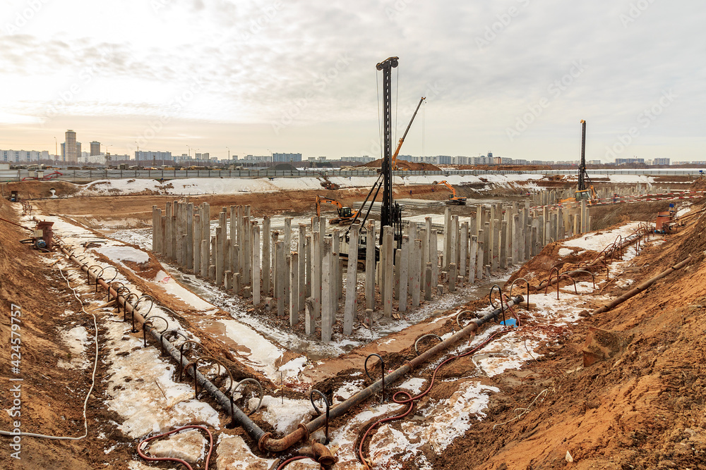 Reinforced concrete piles of new building, tower crane. Hydraulic ...