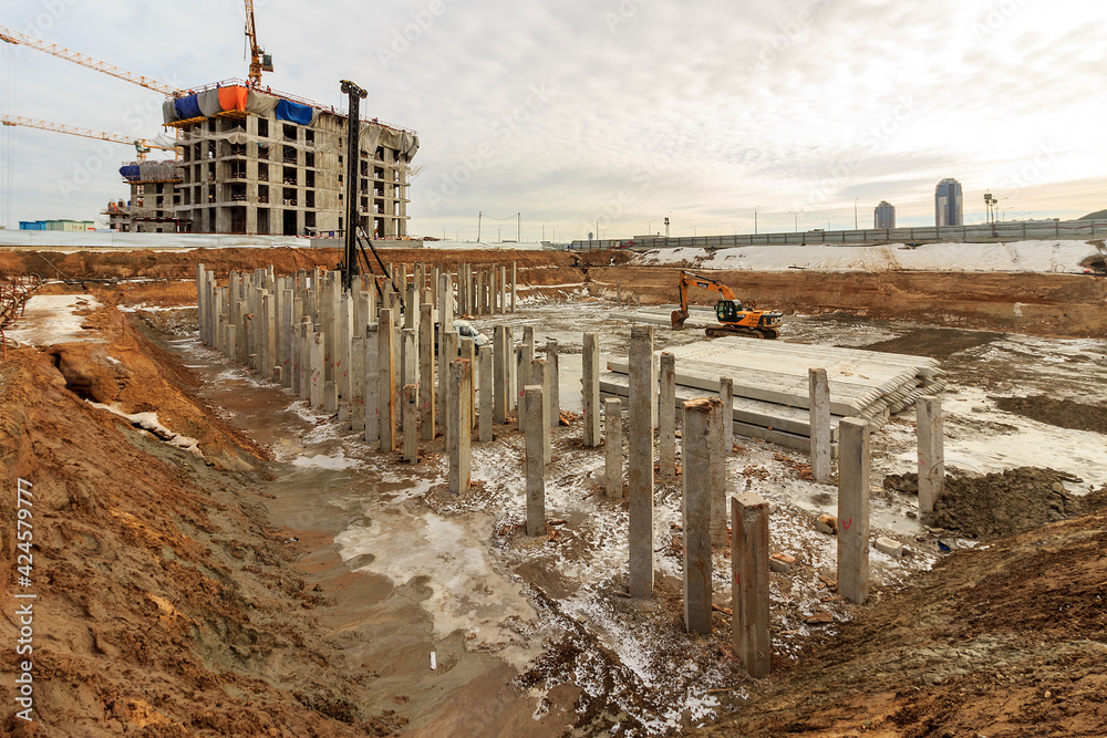 Reinforced concrete piles of new building, tower crane. Hydraulic ...