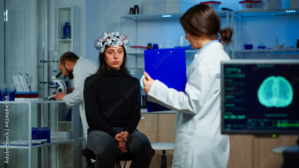 Neuroscience doctor holding clipboard showing treatment against brain ...