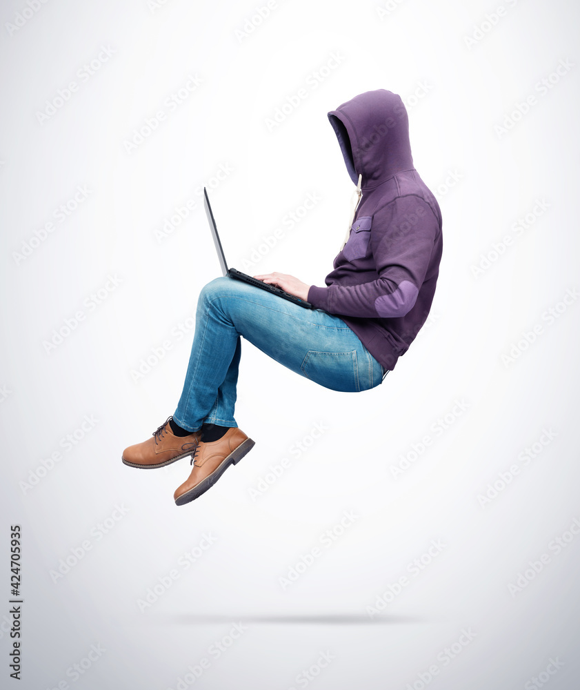 Anonymous hacker in a hooded sweatshirt without a face levitates in the ...