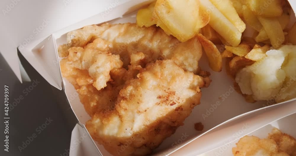 Top view of traditional Greek fried cod fish in card boxes for delivery ...
