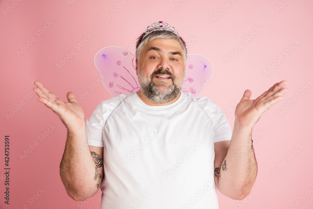 Handsome caucasian plus size male model isolated on coral pink studio ...