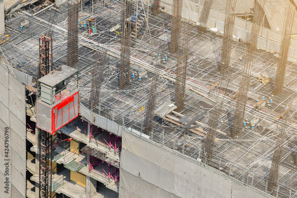 Construction workers are working on the concrete floor structure of the ...