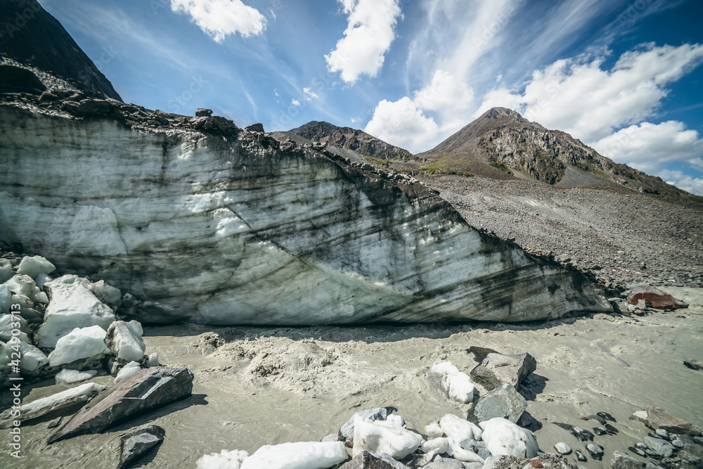 Scenic highlands landscape with mountain river beginning from glacier ...
