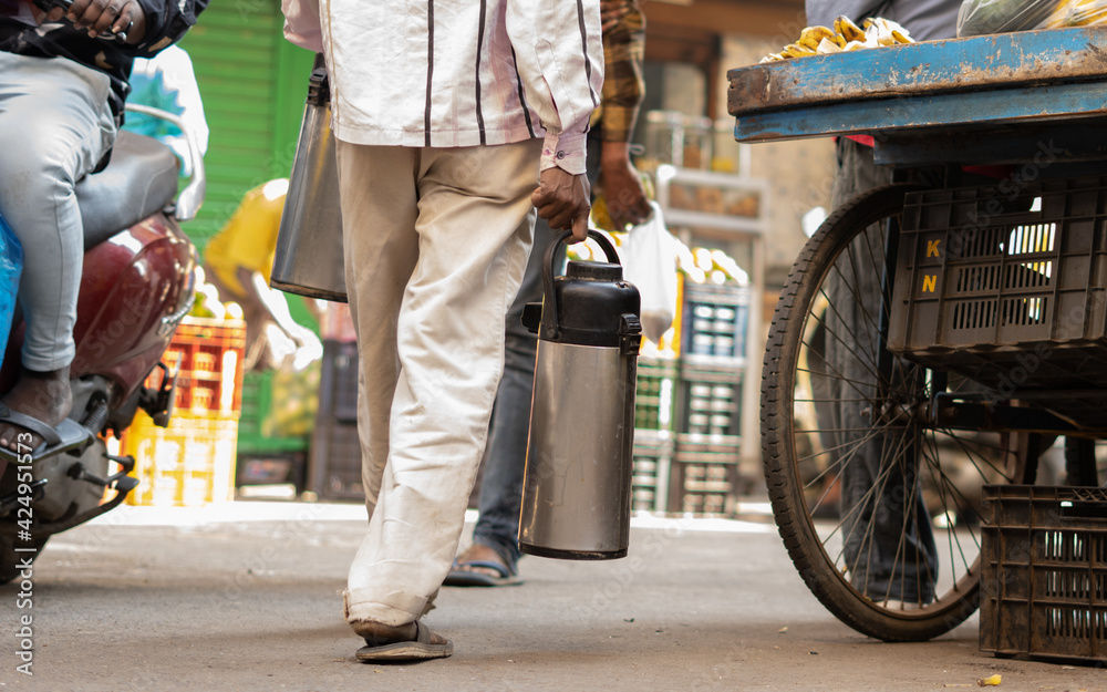 Chaiwala carrying tea on the streets with two big tea flask in the ...