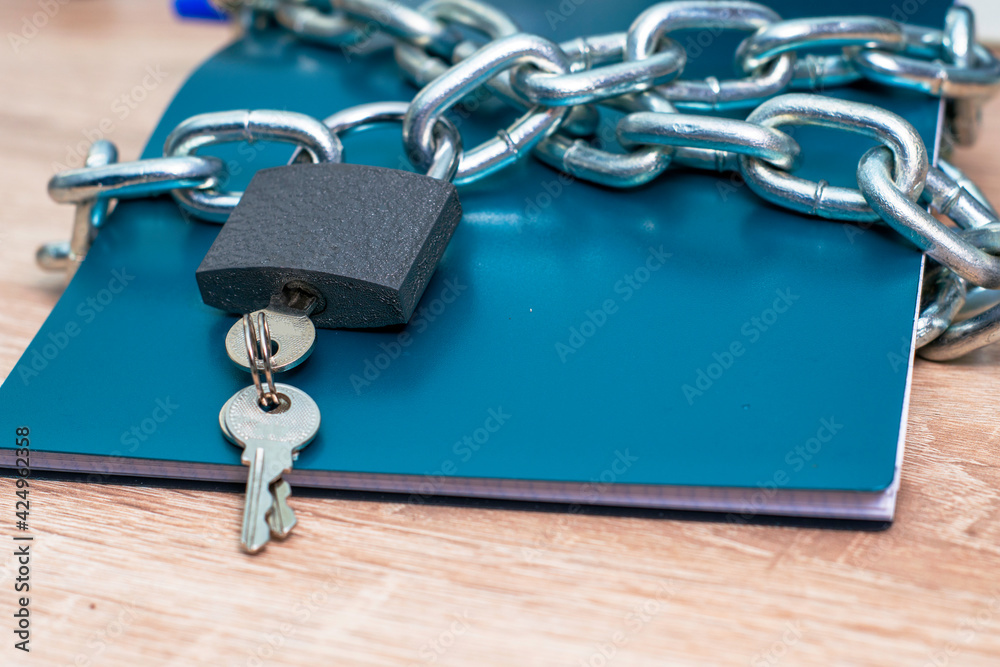 notebook for writing wrapped with an iron chain closed with a lock with ...