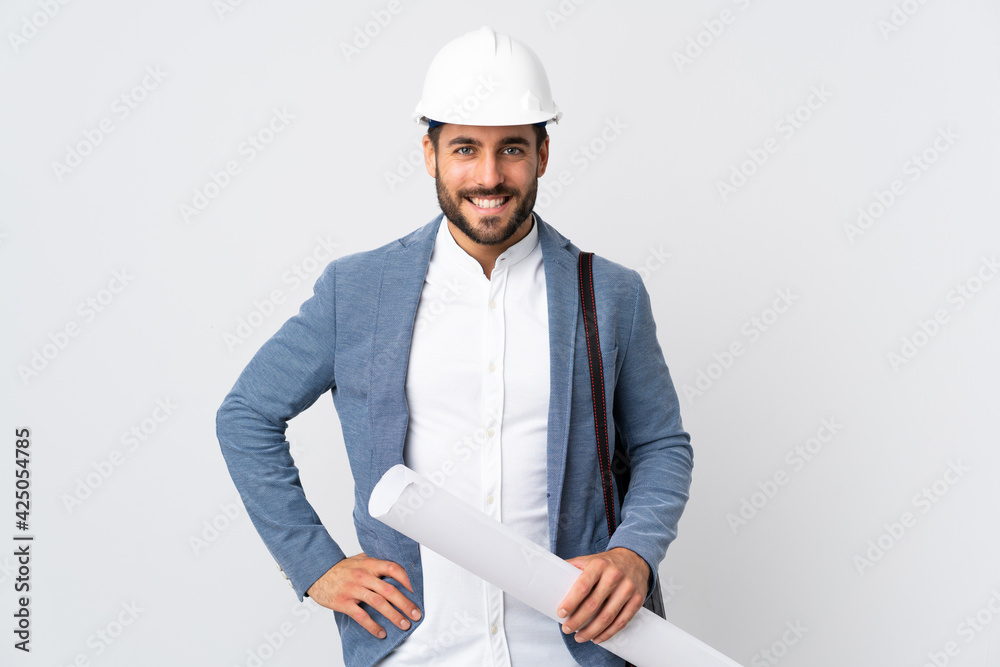Young architect man with helmet and holding blueprints isolated on ...