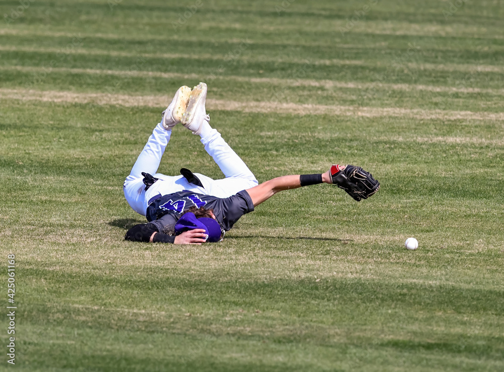 Action photo of athletic high school baseball player making an amazing ...