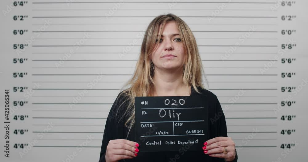 Side profile mugshot of female person with dyed hair raising head and ...