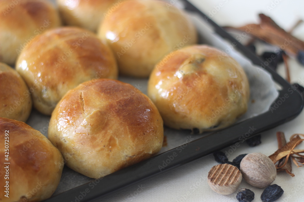 Freshly baked hot cross buns. A sweet fruit bun lightly spiced with ...