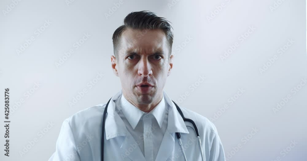 Close-up of angry doctor scolding and shouting at employees threatening ...