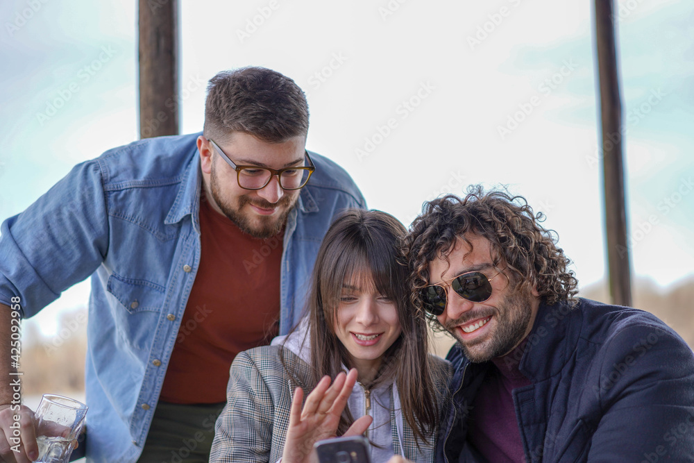 Multiracial group of friends having a coffee together. Two men and a ...