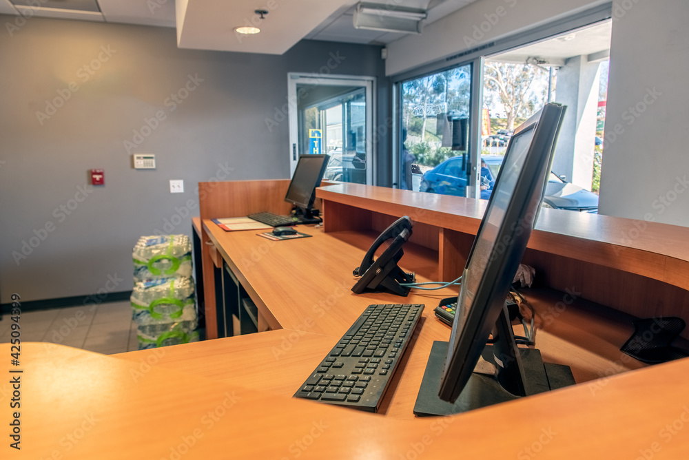 Customer service counter with computer, keyboard, and phone sit ready ...