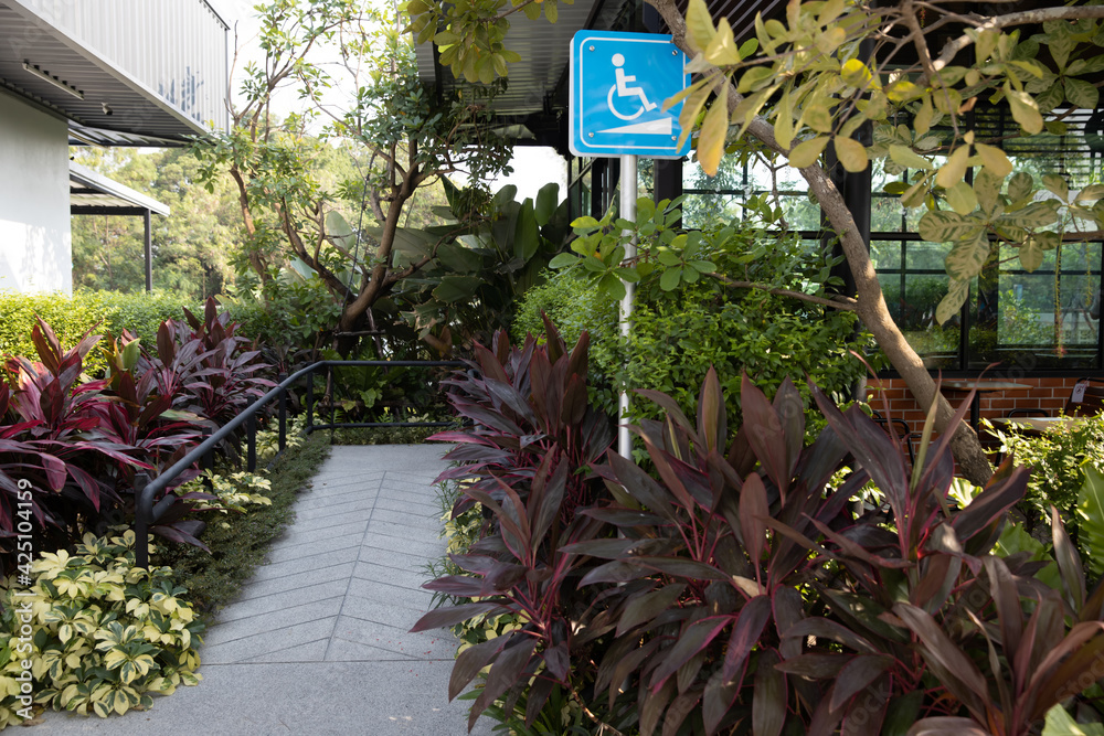 Disabled way sign in front of building. Handicapped sign traffic symbol ...