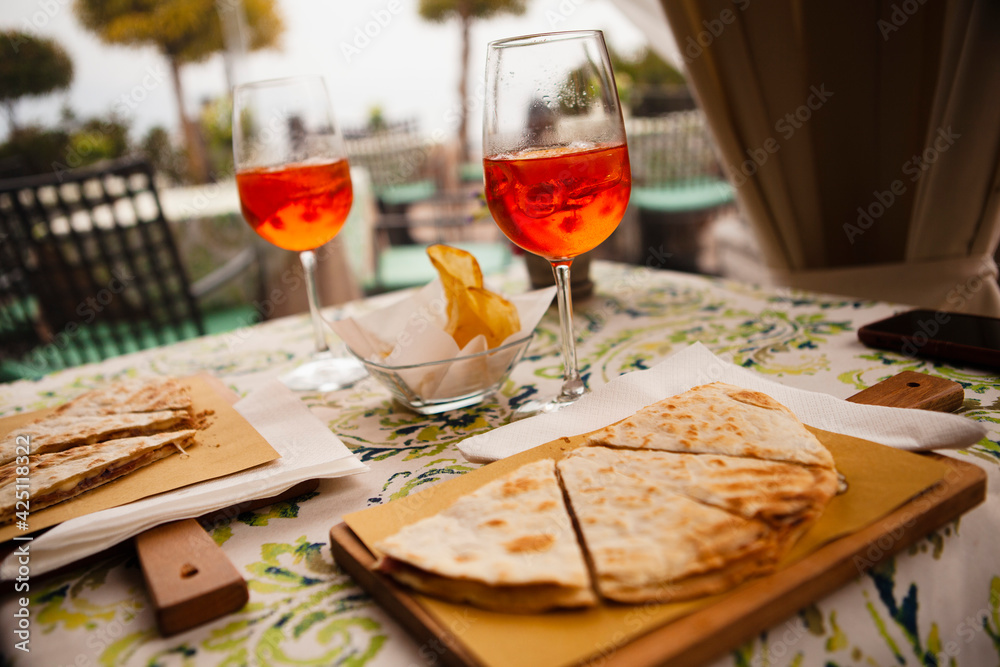 Italian traditional street food and aperitif. Aperol spritz with ...