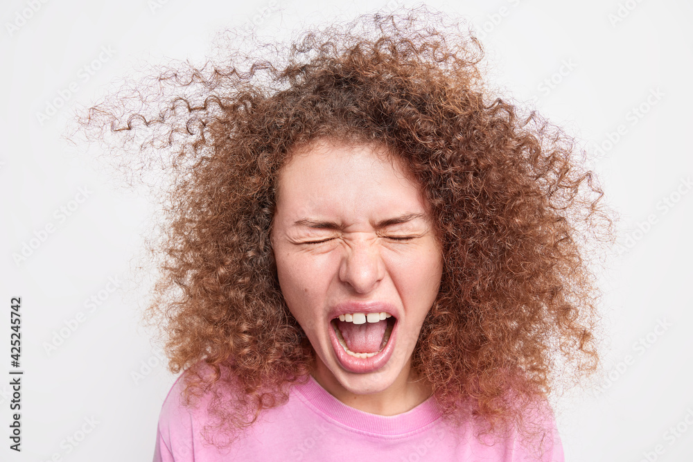 Headshot Of Emotive Young Caucasian Woman Screams Loudly Keeps Mouth