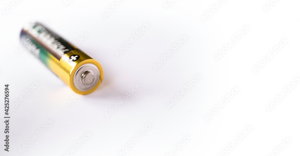 Close-up of a lying penlight battery on white, focus on the battery ...