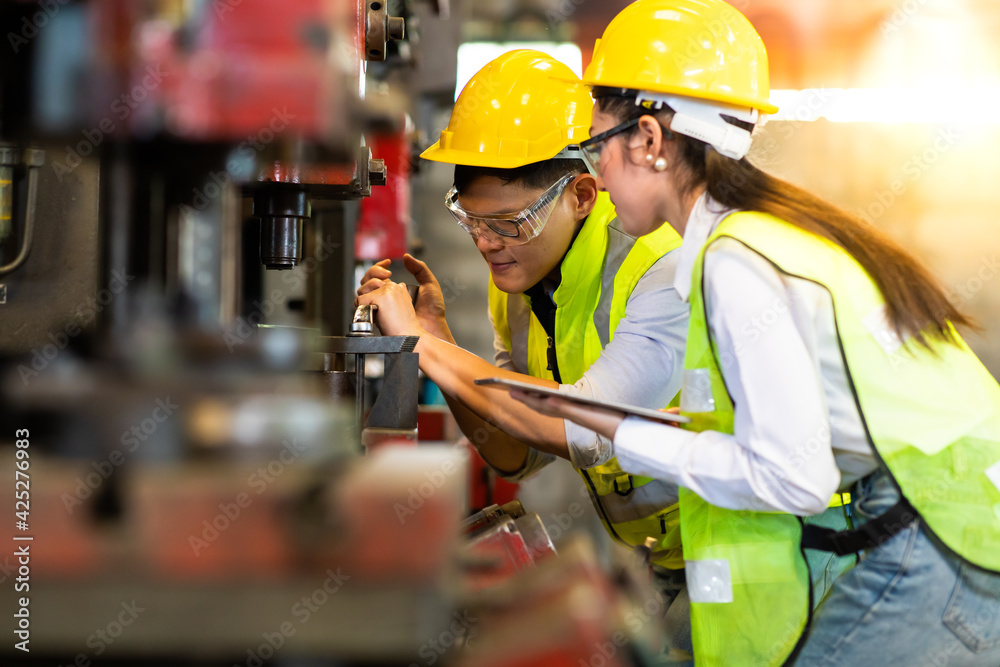 Woman trainee and engineer man wearing safety goggles and hardhat ...