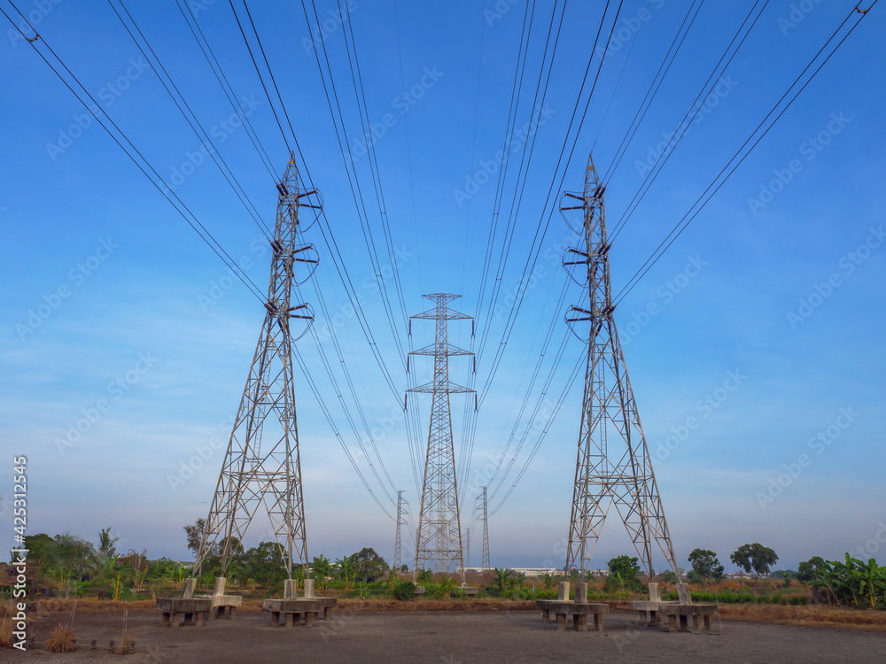 transmission towers with electricity power line over blue sky and white ...