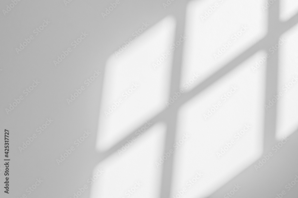 Abstract light reflection and grey shadow from window on white wall ...