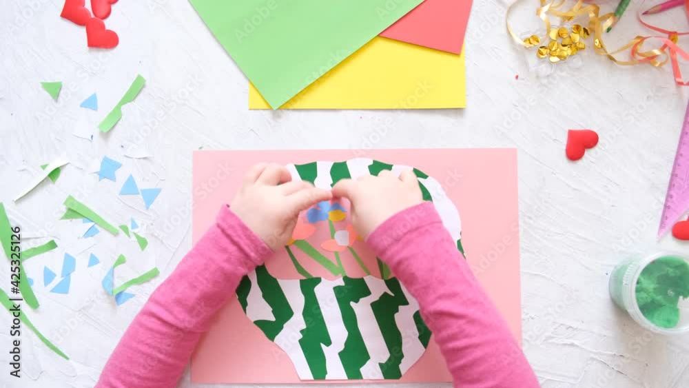 Child making homemade greeting card. little girl making basket with ...