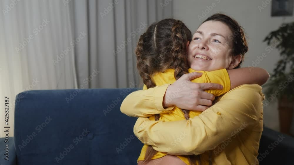 daughter hugs mom. happy family a lockdown stay home concept. mom and ...