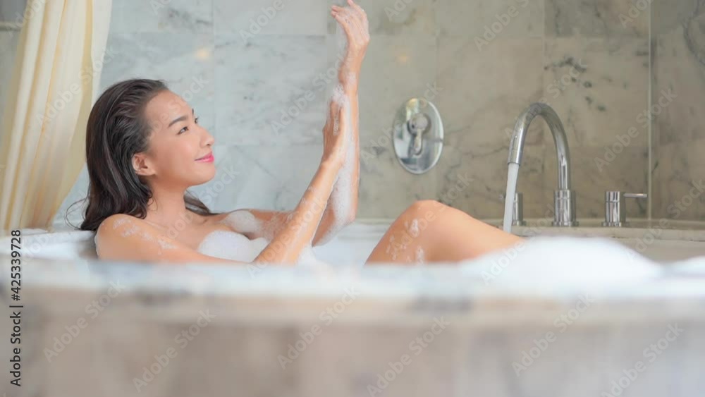 Medium close of a beautiful woman taking a luxurious bubble class. Stock ビデオ | Adobe Stock