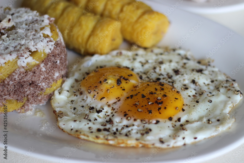 Steamed finger millet flour cake with a generous layer of fresh coconut ...