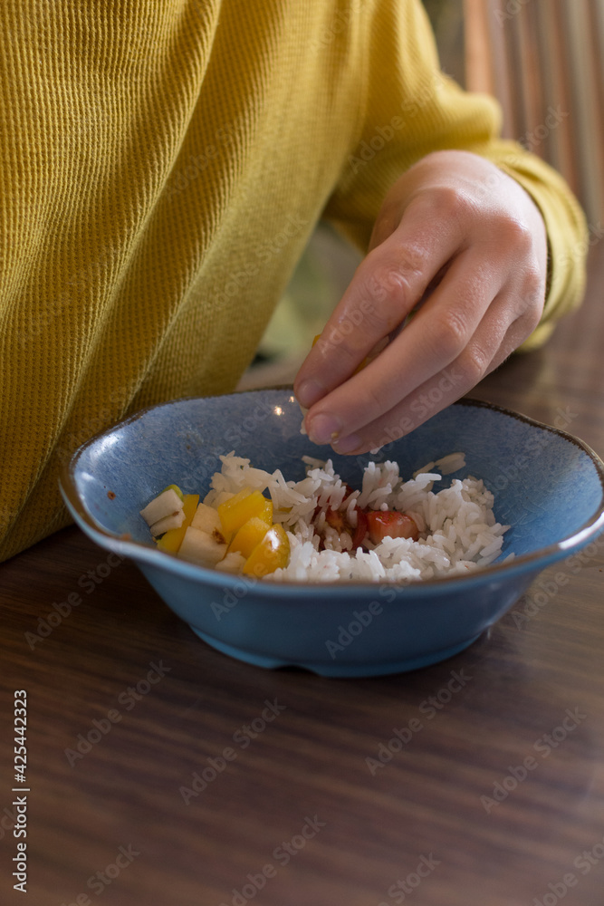 Eating rice and vegetables with hands: a special needs child eats ...