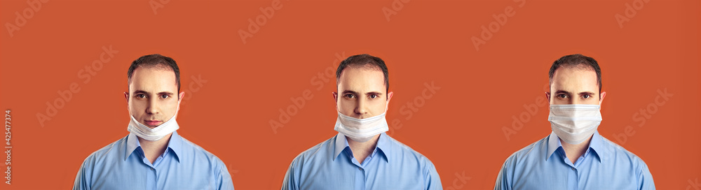 A studio portrait of a man wearing a medical mask that is not properly ...