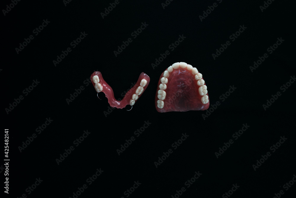 Full removable plastic denture of the jaws. A set of dentures on a ...