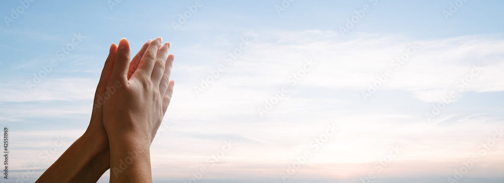 Praying hands. Folded hands in prayer to the sky Stock Photo | Adobe Stock