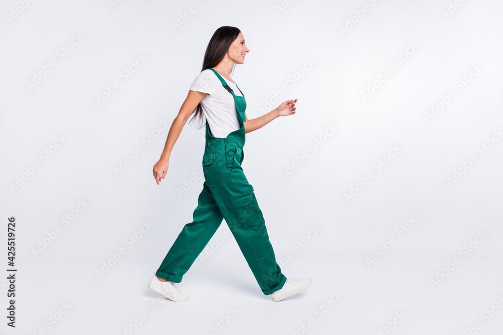 Profile photo of positive pretty lady step wear green overall sneakers ...