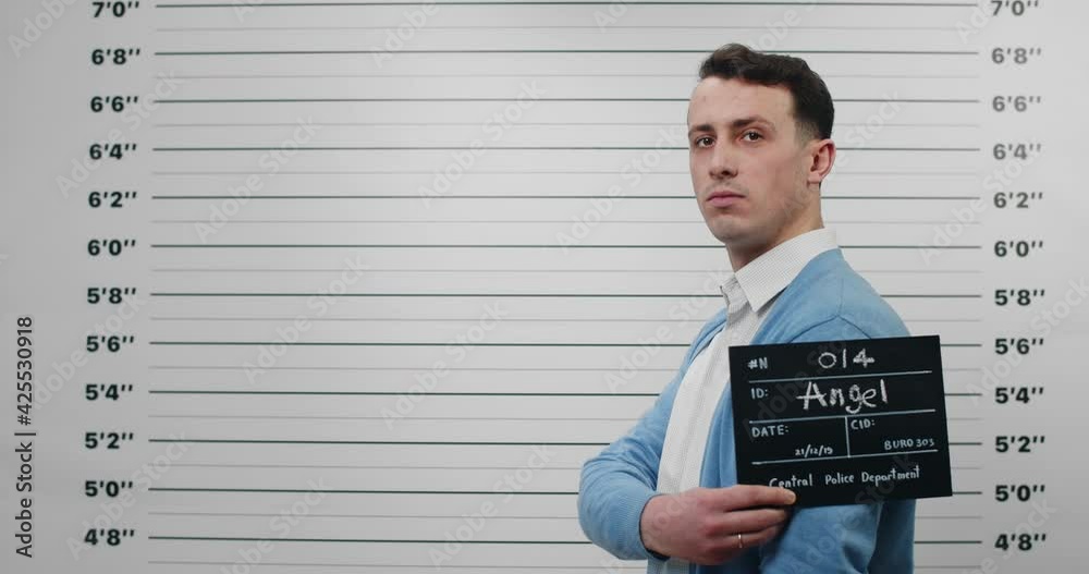 Mugshot of male person in shirt and cardigan turning head while ...