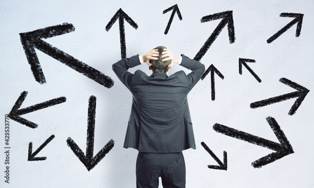 Difficult decision concept with man in black suit grabs his head in ...