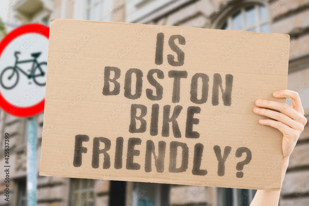 The question " Is Boston bike friendly? " on a banner in men's hand ...
