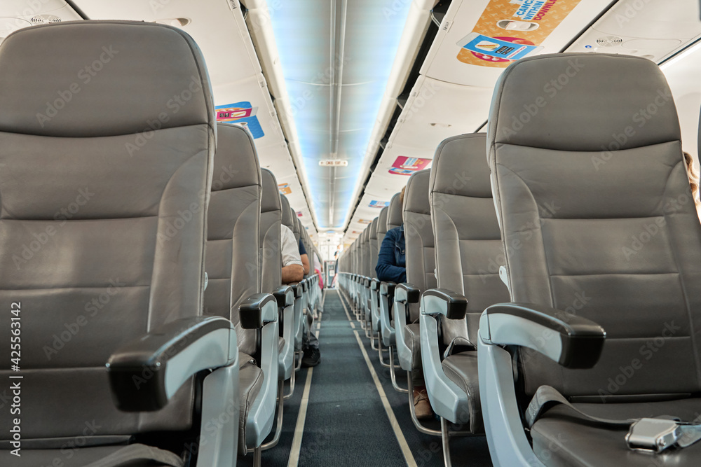 Half empty cabin of a passenger plane. Empty seats for passengers ...