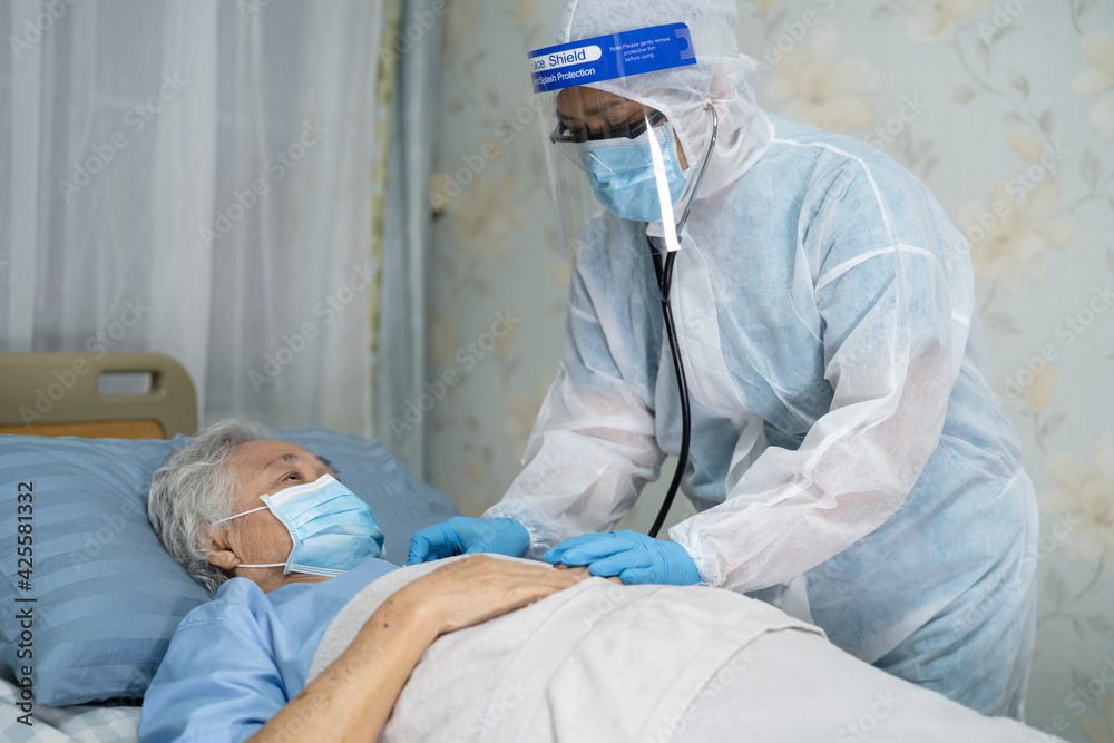 Asian doctor wearing face shield and PPE suit new normal to check ...