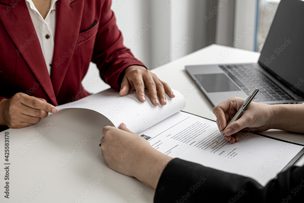 The job applicant is checking the resume with the Human Resources ...