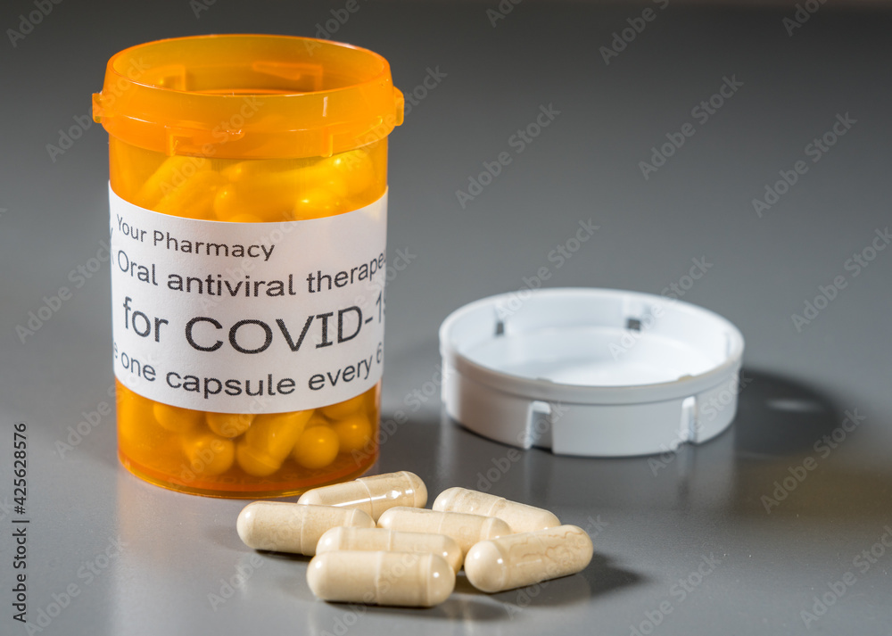 Prescription bottle and capsules illustrating trials of oral antiviral ...